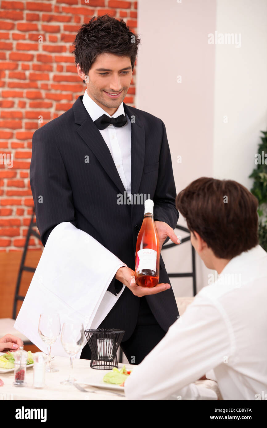 Waiter presenting wine bottle hi-res stock photography and images - Alamy