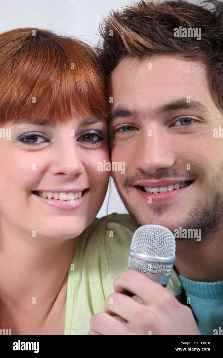 portrait of young couple singing Stock Photo - Alamy