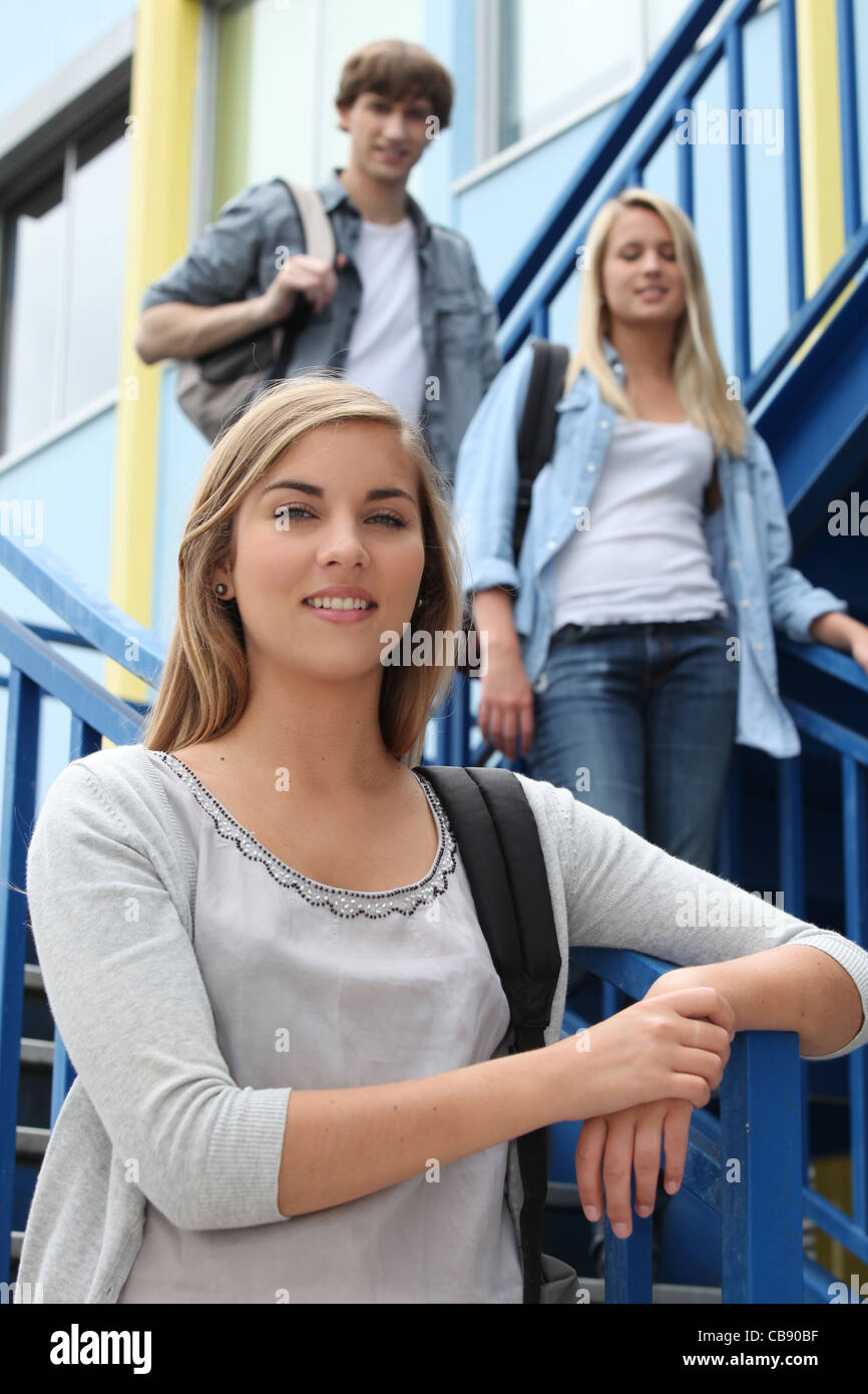 Three students standing on an exterior staircase Stock Photo - Alamy