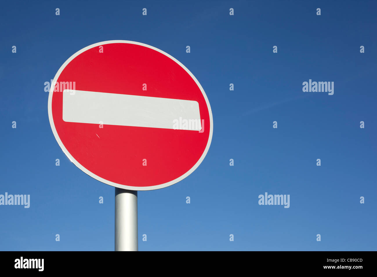British no entry red and white round road sign and blue sky Stock Photo ...