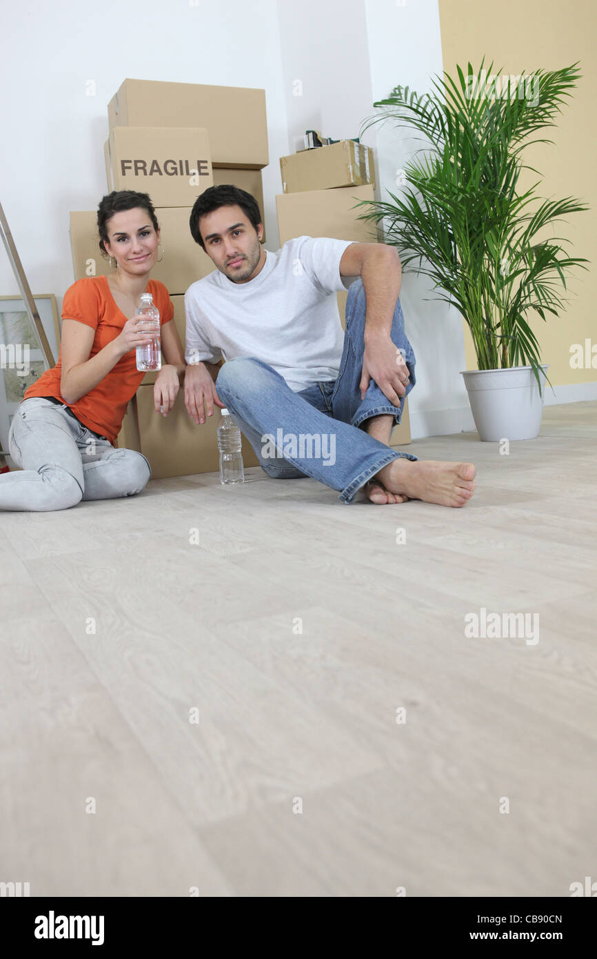 Tired couple on moving day Stock Photo - Alamy