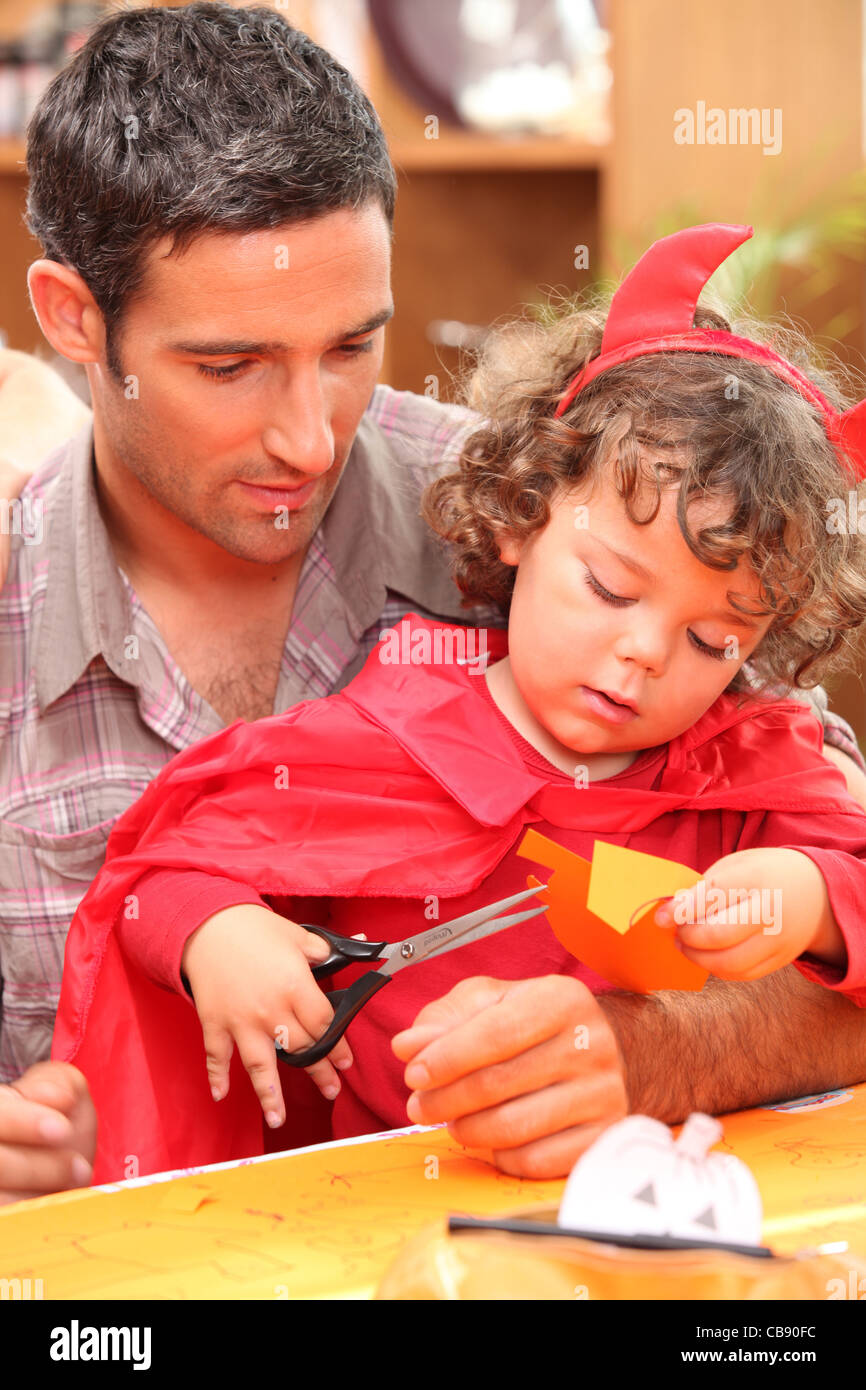 Dad with his child dressed as a devil for Halloween Stock Photo - Alamy