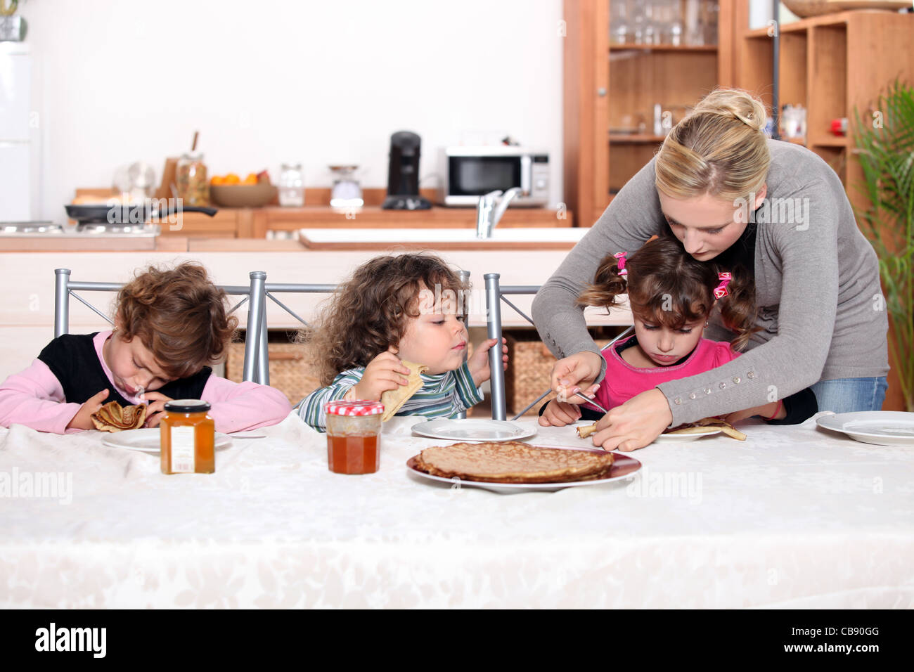 Young children eating crêpes Stock Photo - Alamy
