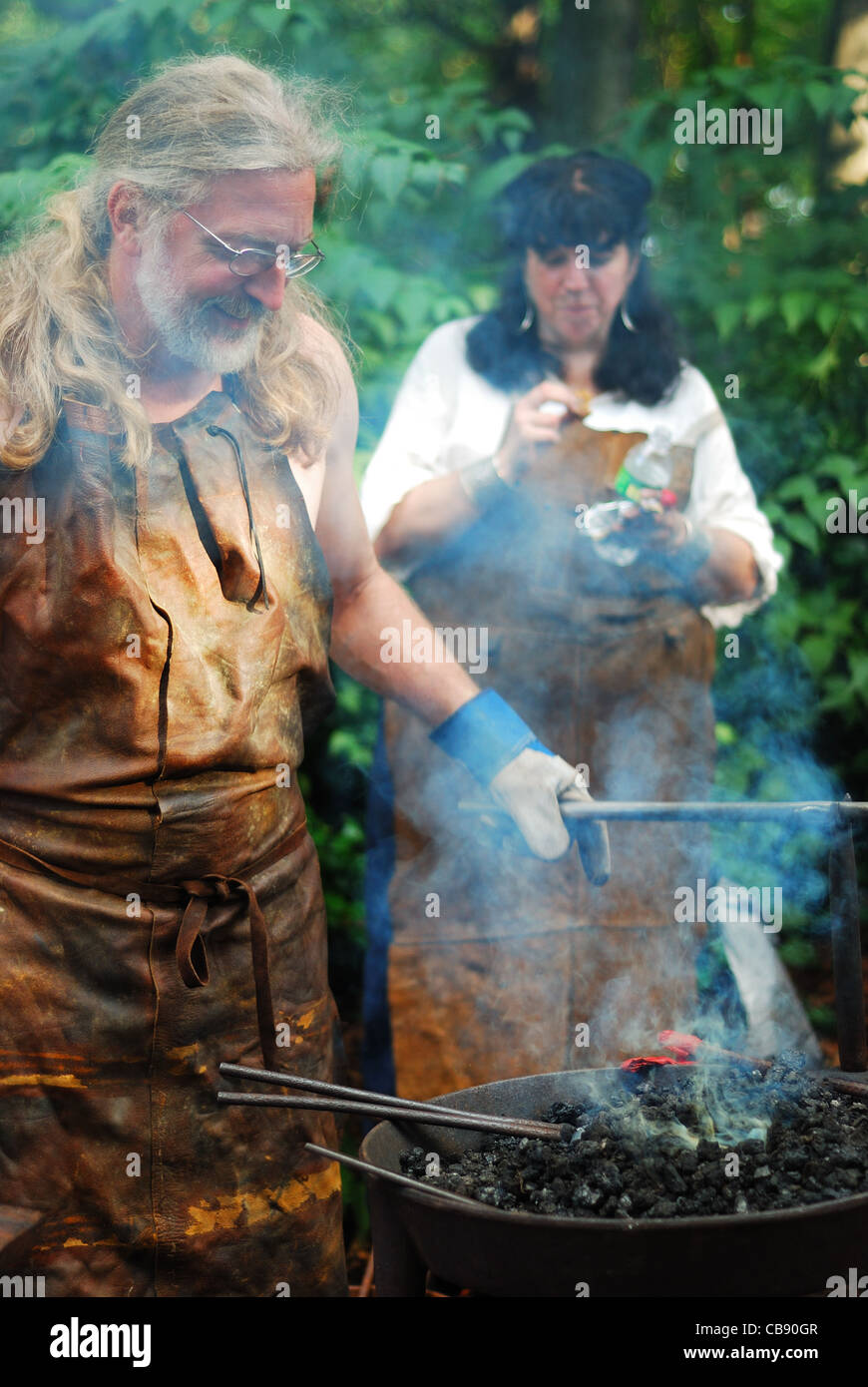 Blacksmith working to build sword in New York Medieval Festival Stock ...