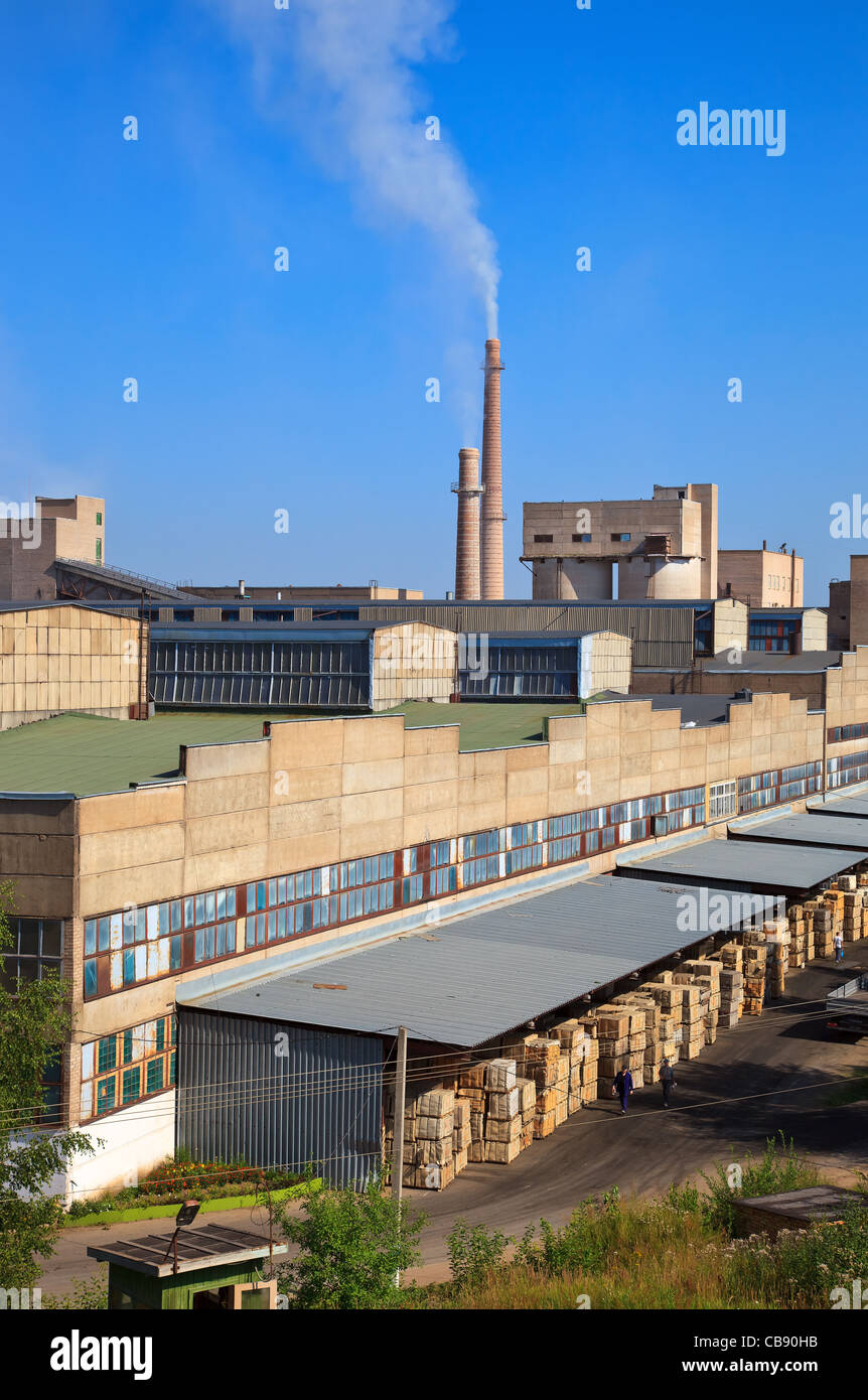 Large factory with smoking chimneys against the blue sky Stock Photo ...
