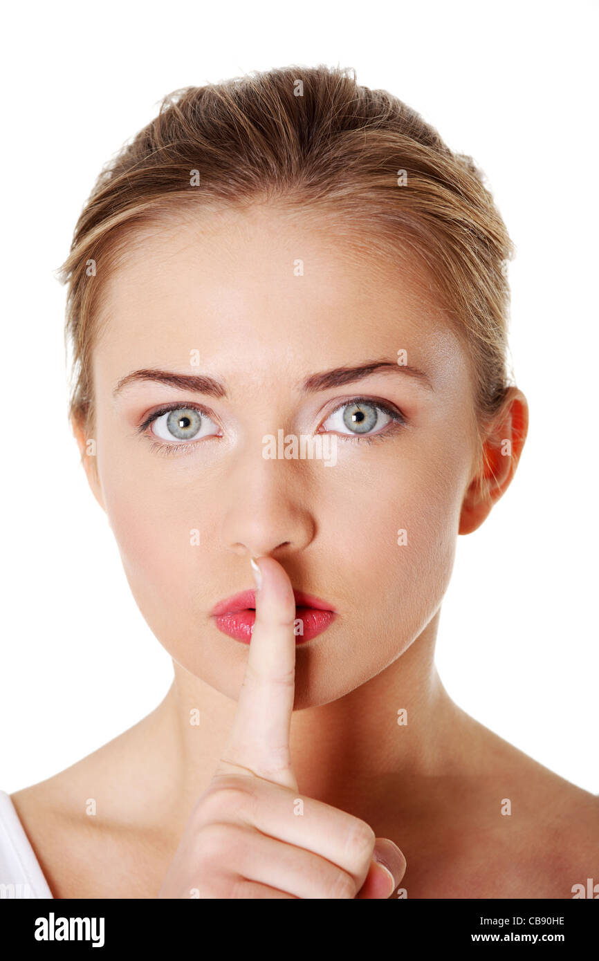 Woman making a keep it quiet gesture Stock Photo - Alamy