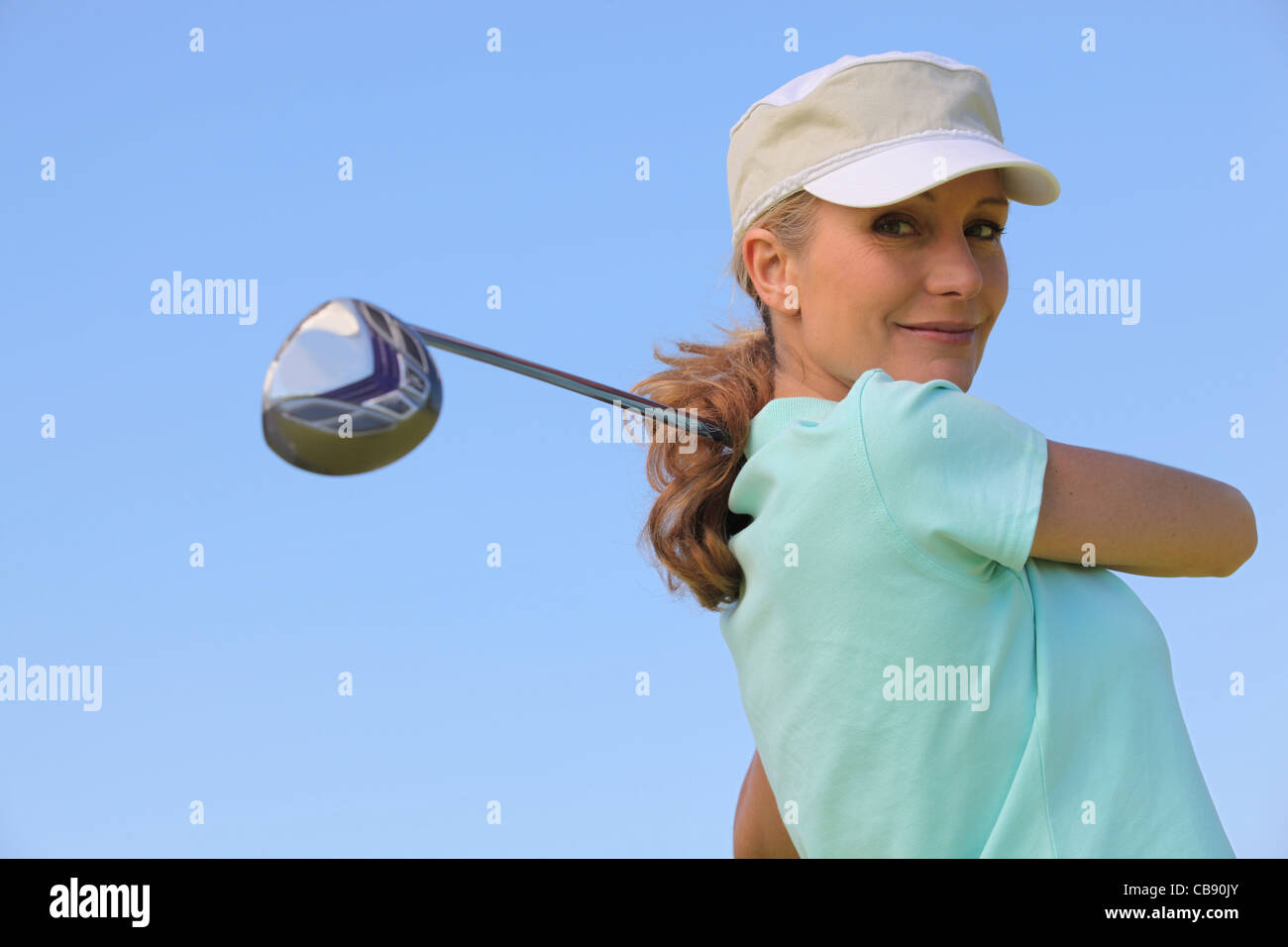 Golfer taking a swing Stock Photo - Alamy
