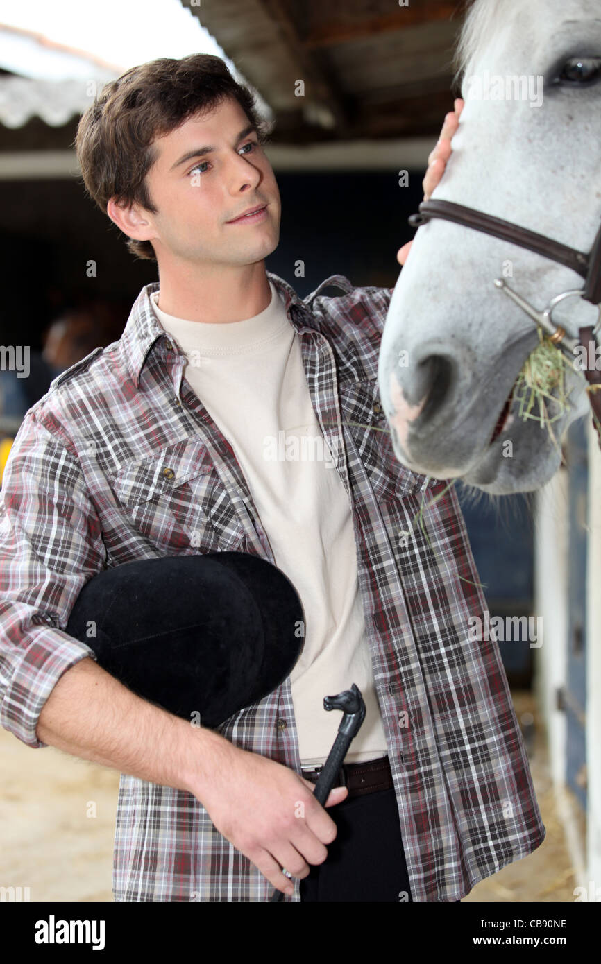 A young man with his horse Stock Photo - Alamy
