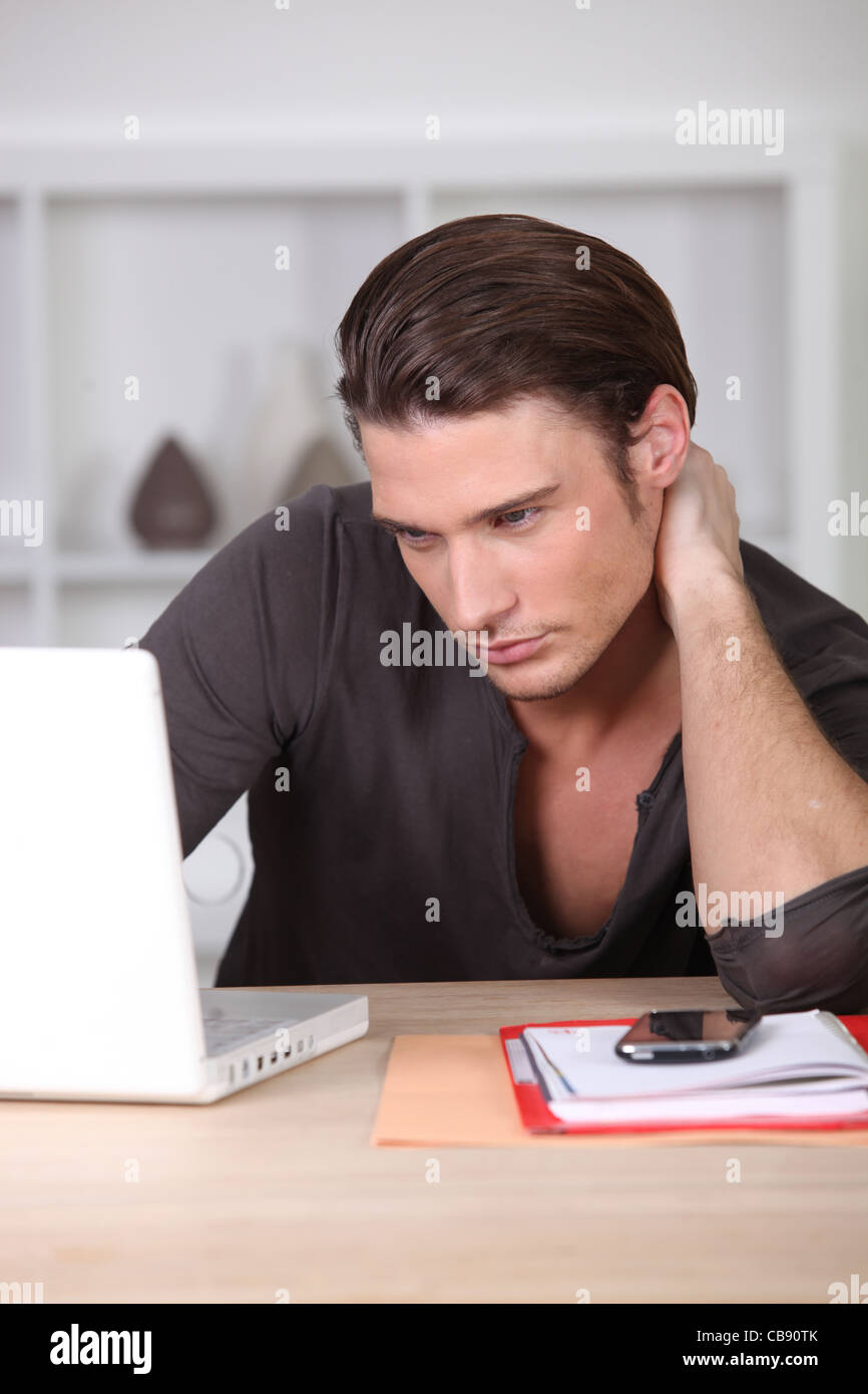 young handsome man working on laptop Stock Photo - Alamy