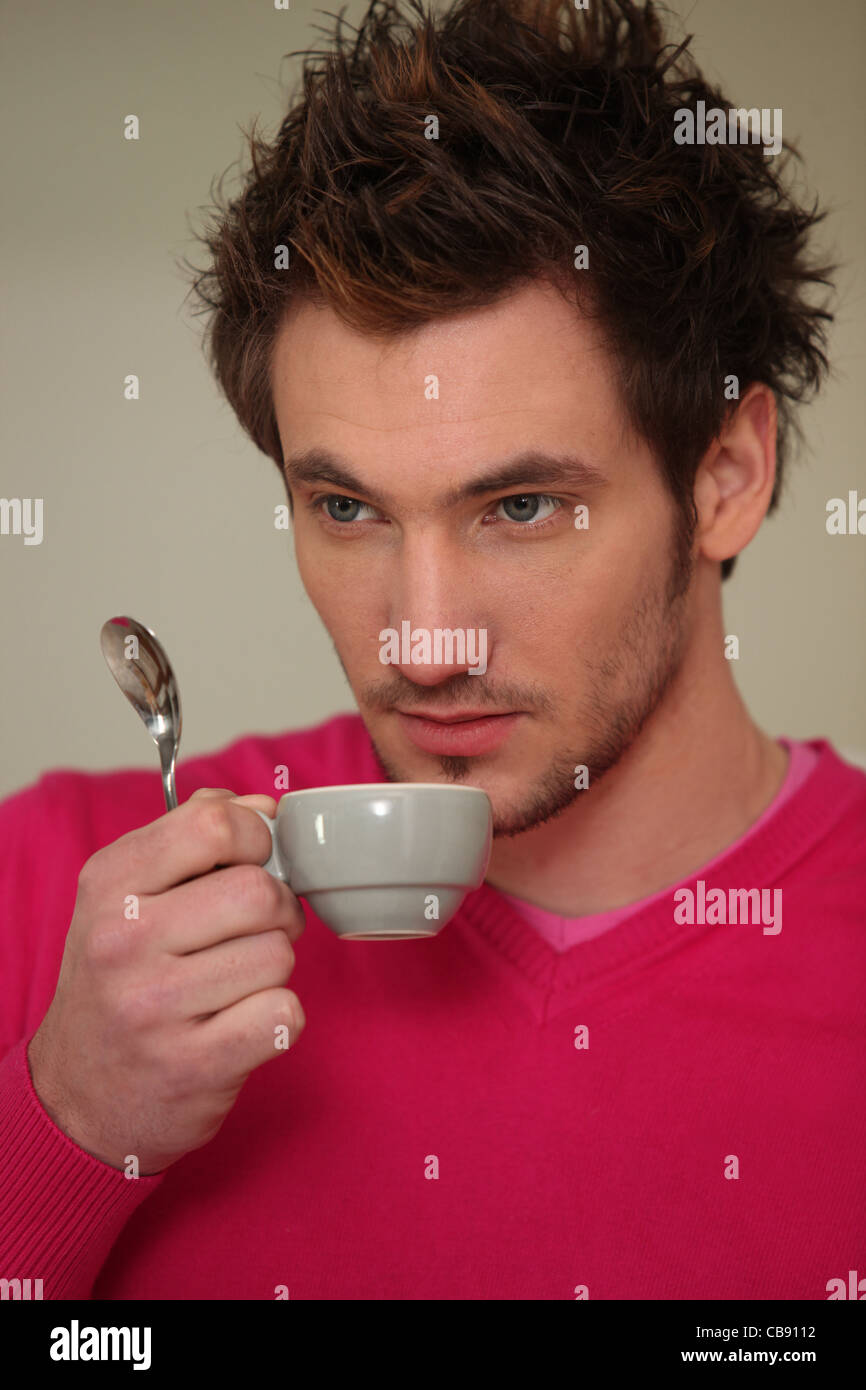Young man drinking expresso Stock Photo - Alamy