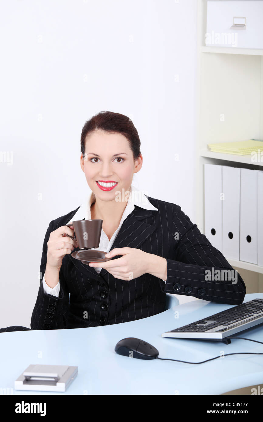 Front View Portrait Of A Beautiful Young Smiling Business Woman Sitting