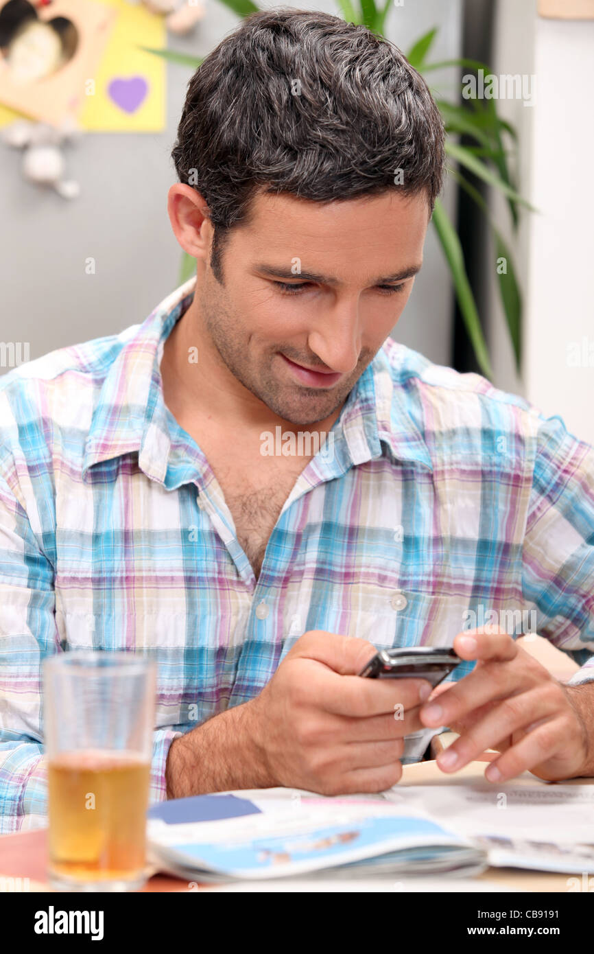 man sending a text message with his cell Stock Photo - Alamy