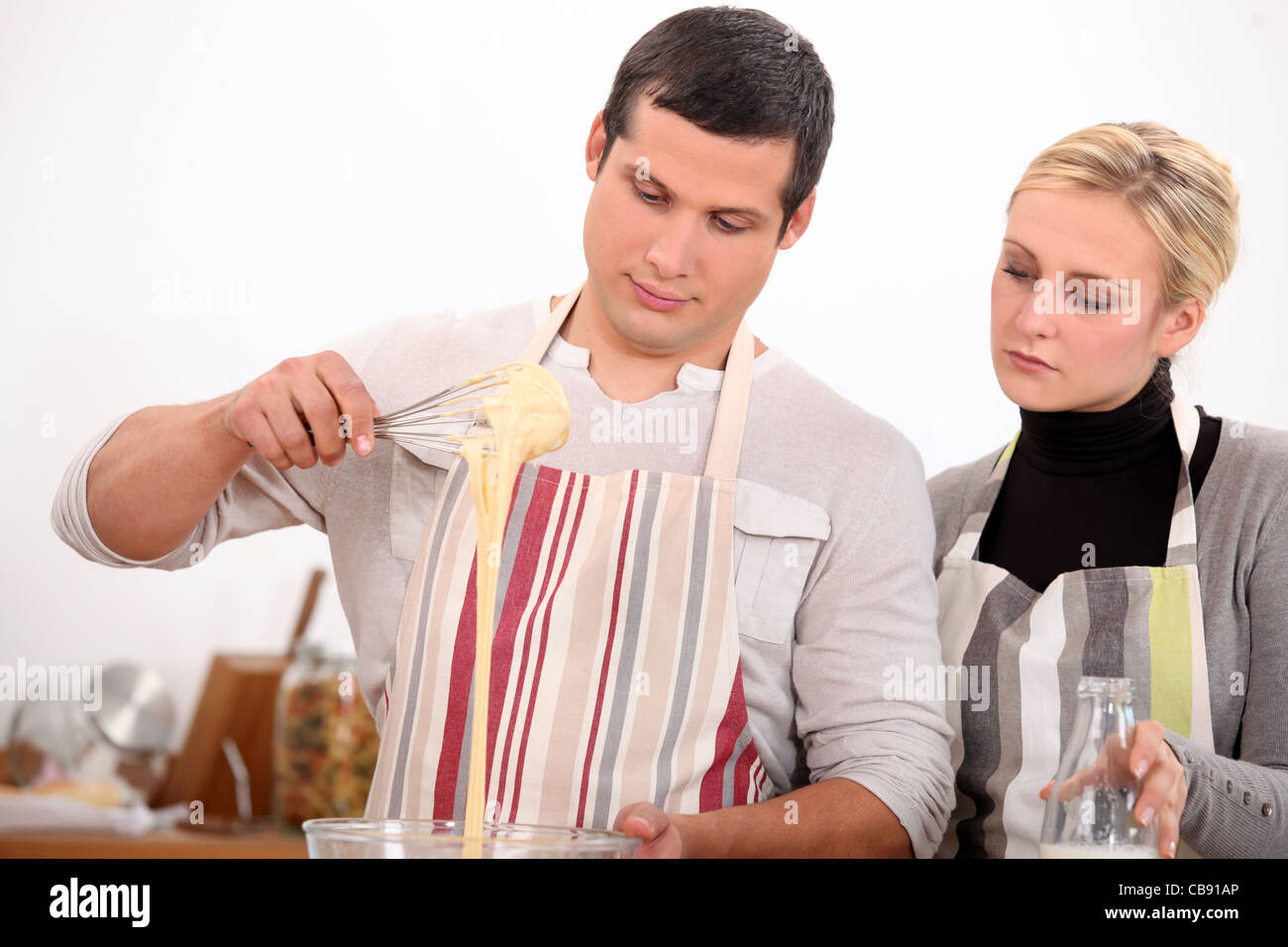Couple making a recipe Stock Photo - Alamy