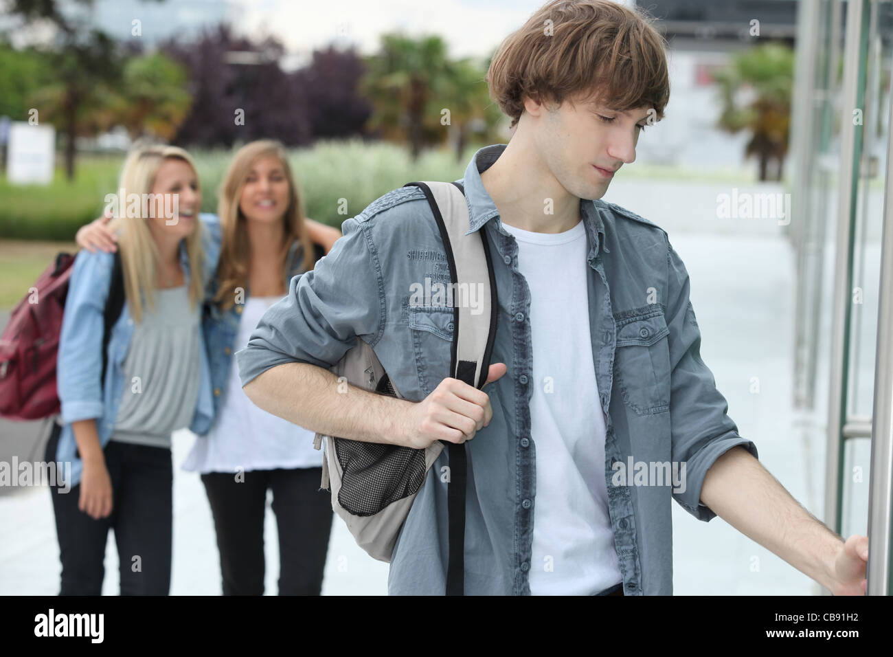 Three teenagers arriving at college Stock Photo - Alamy