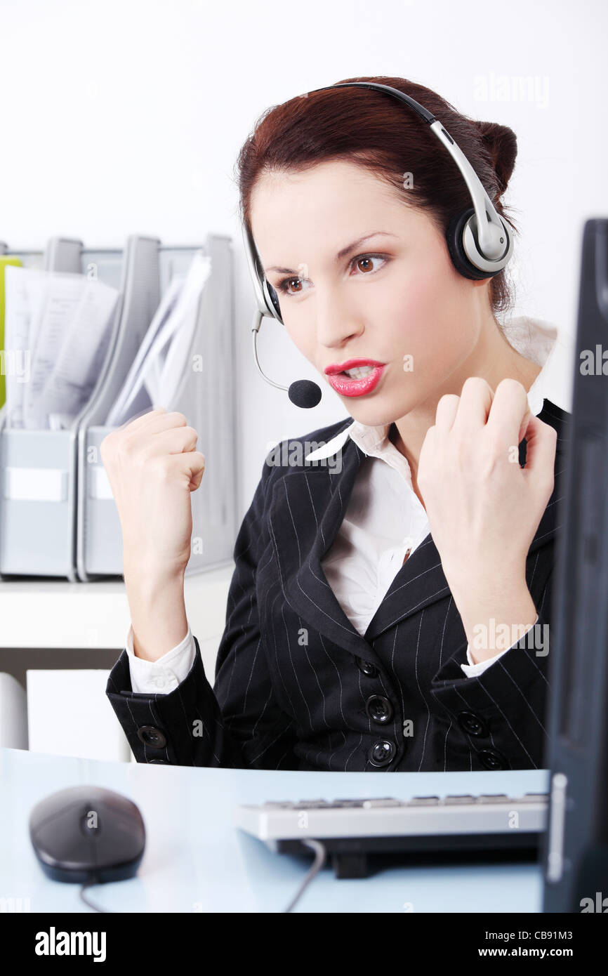 Portrait of a furious business woman being shouting through the ...