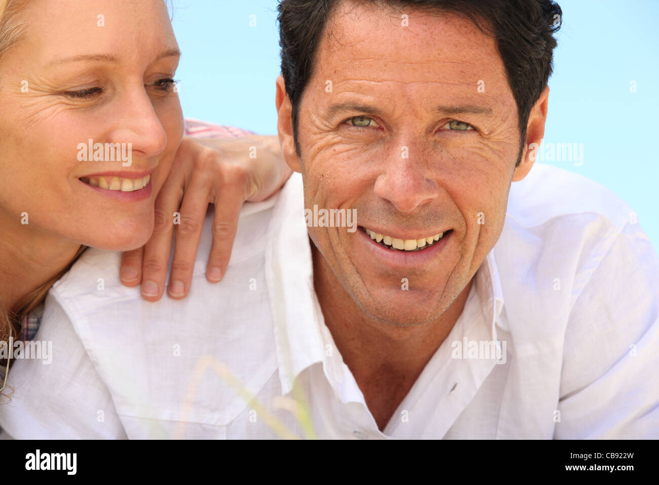 Happy couple and blue sky Stock Photo - Alamy