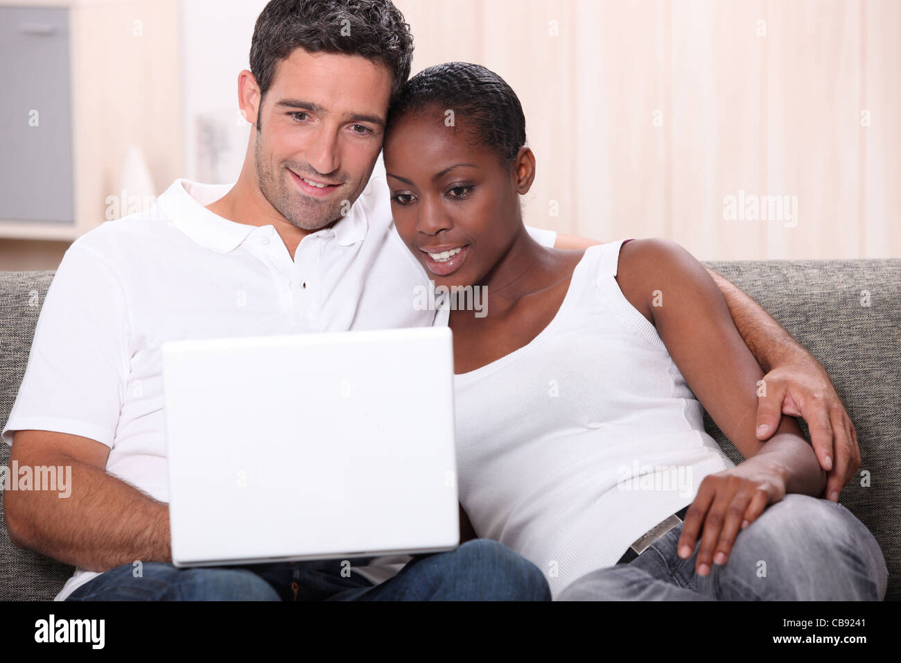 Couple watching DVD on laptop Stock Photo - Alamy