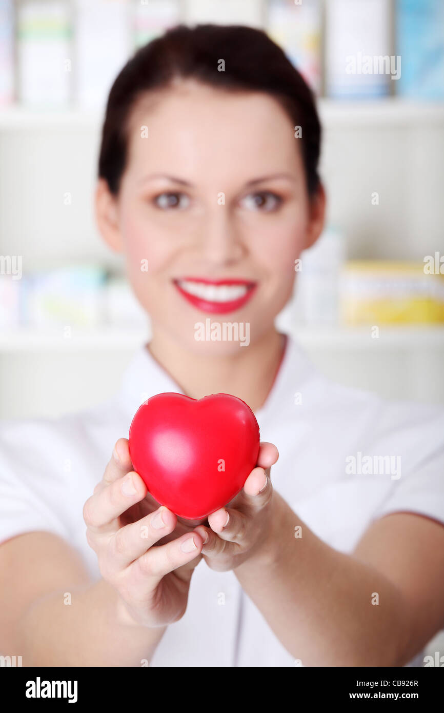 Closeup on heart in pretty caucasian pharmacist`s hands Stock Photo - Alamy