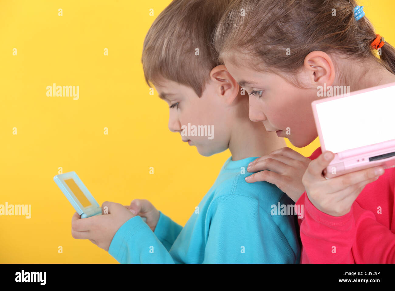 Children playing handheld video games Stock Photo - Alamy