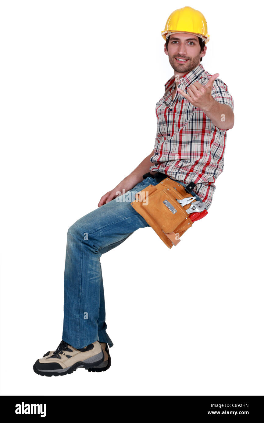 A construction worker making a hand sign Stock Photo - Alamy