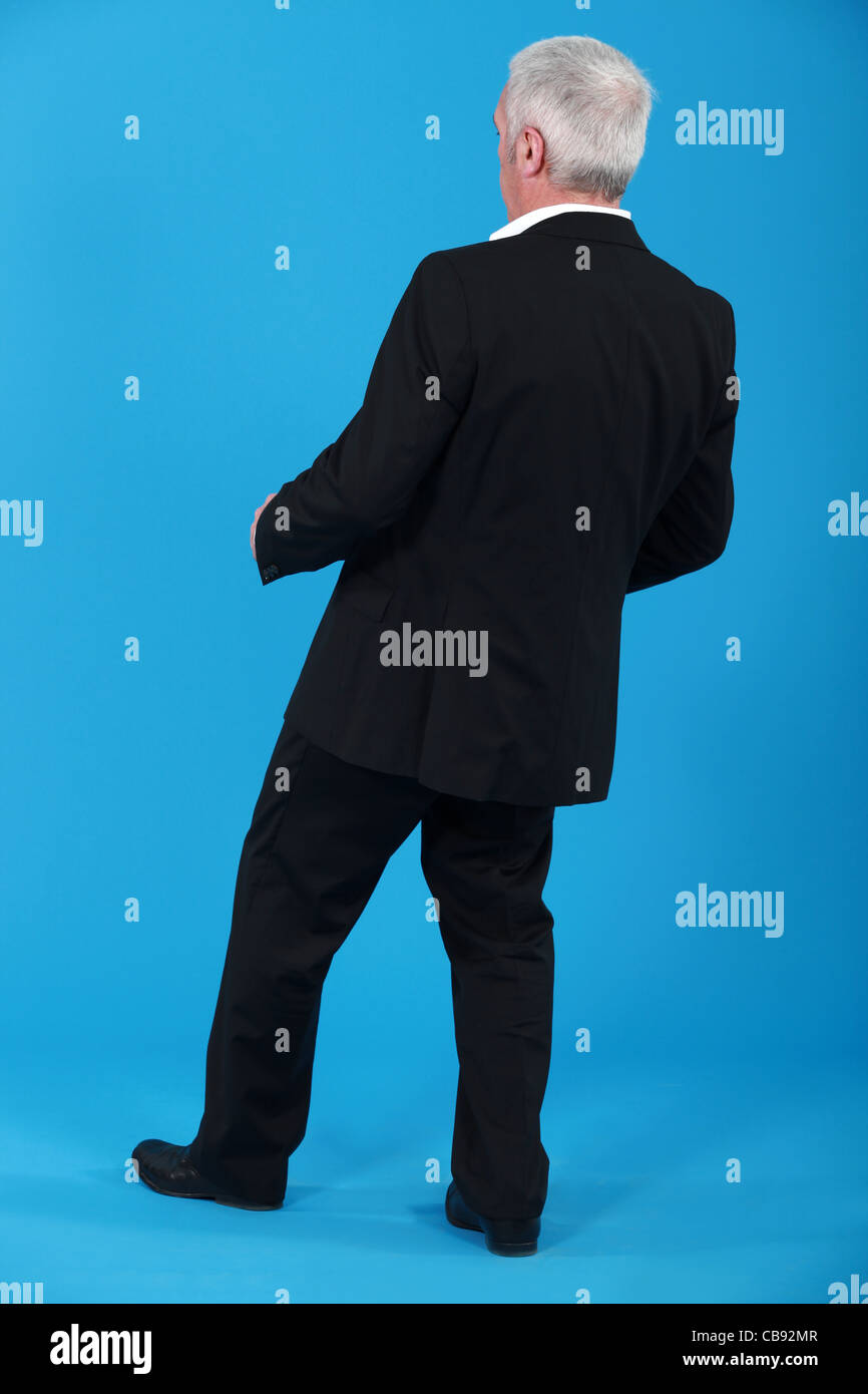 Businessman leaning backwards Stock Photo - Alamy