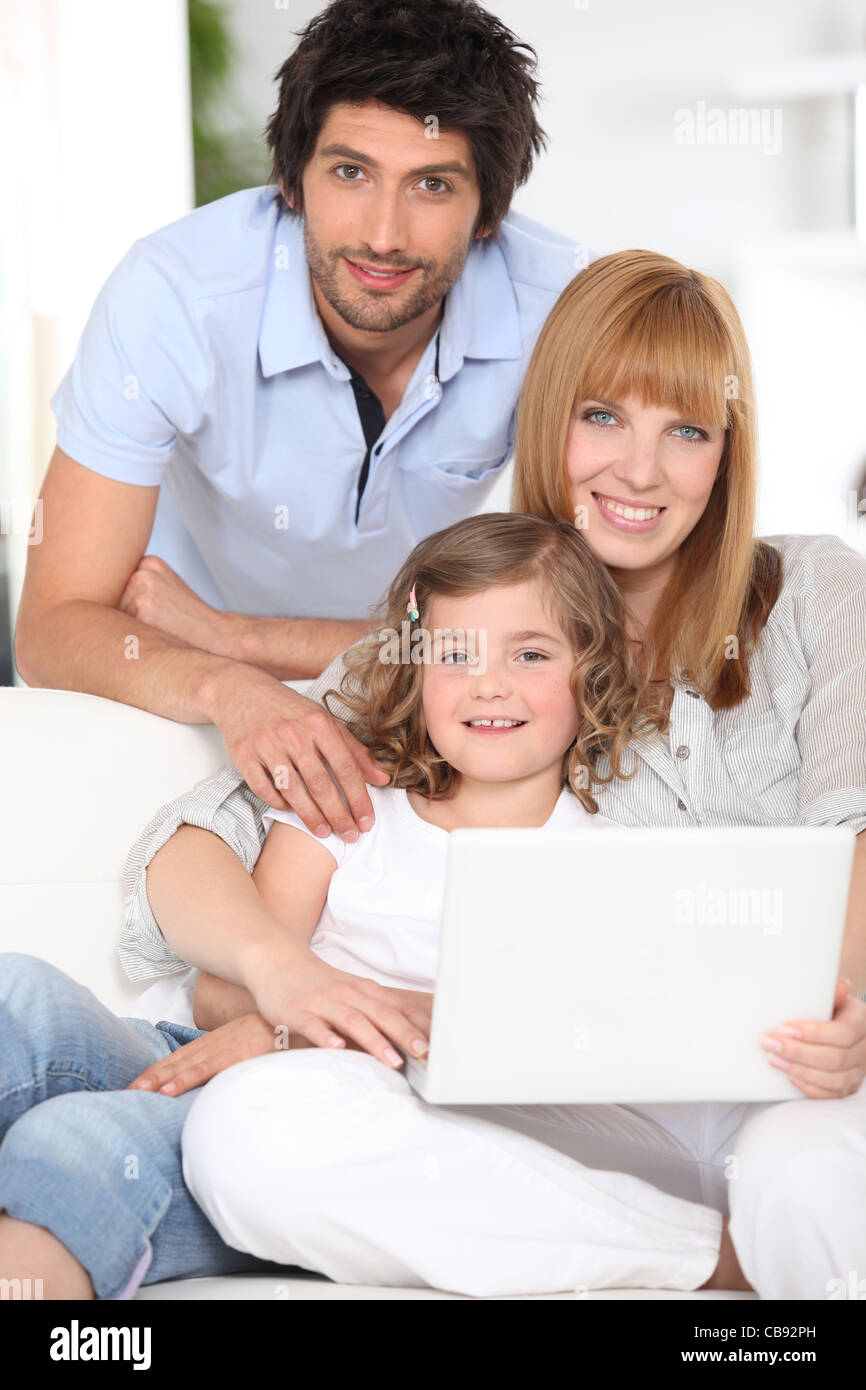 Parents and daughter with laptop computer Stock Photo - Alamy