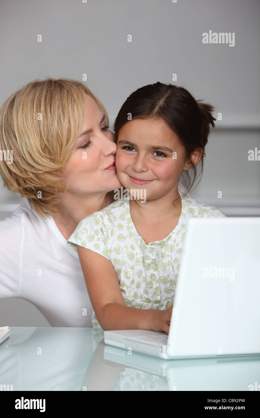 Mother and daughter at laptop computer Stock Photo - Alamy