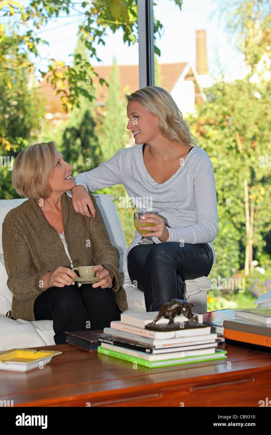 Mother and daughter chatting at home Stock Photo - Alamy