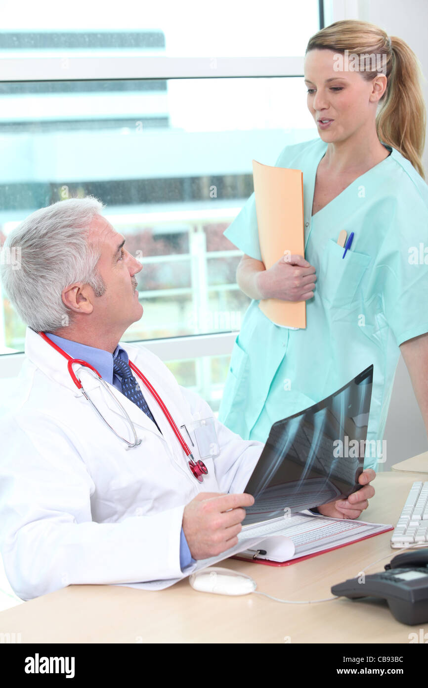Doctor having a conversation with his assistant Stock Photo - Alamy