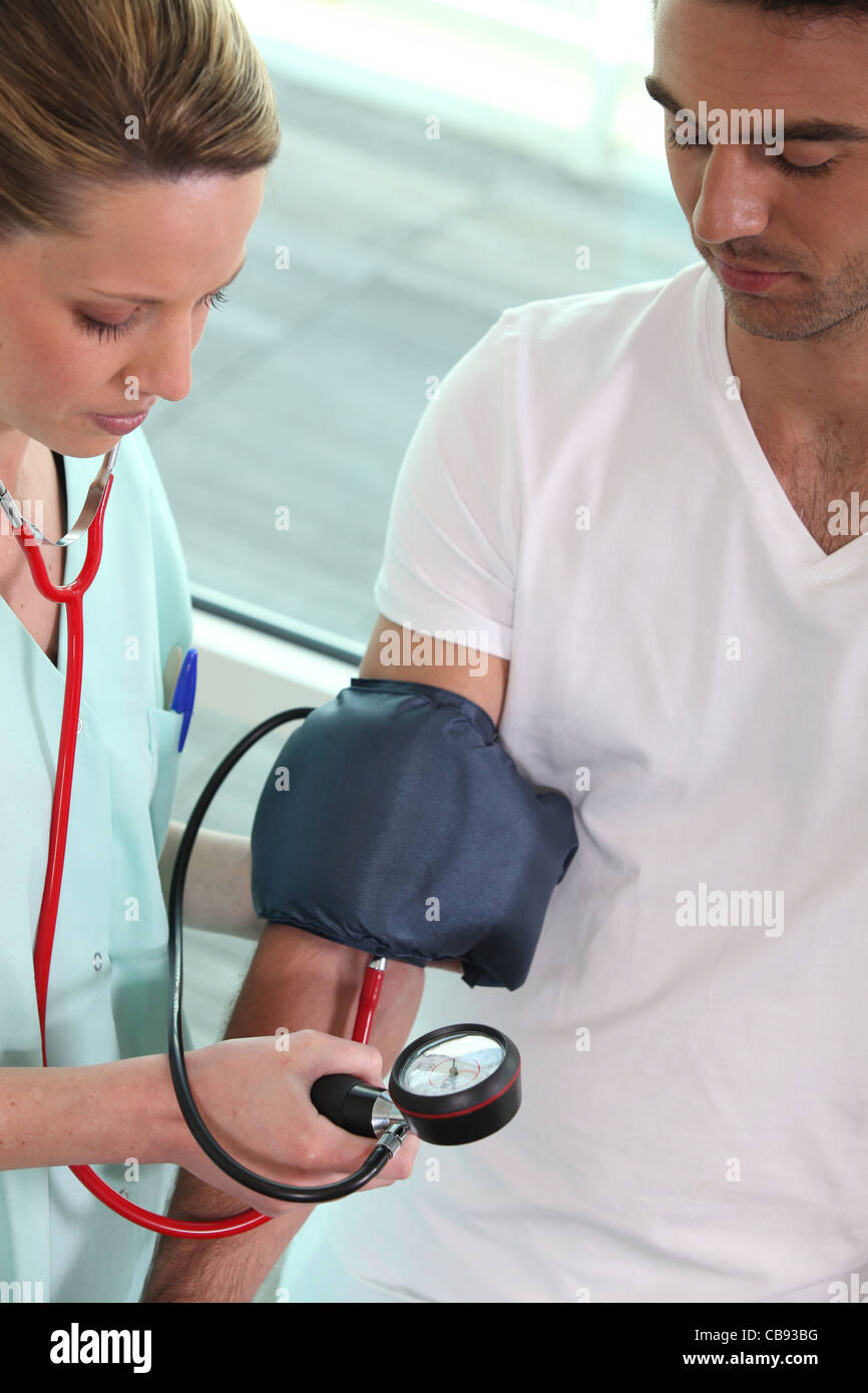 nurse measuring the blood pressure of a patient Stock Photo - Alamy