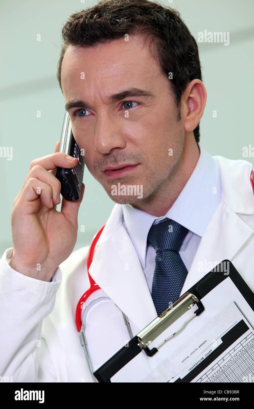 young doctor talking on his cell phone Stock Photo - Alamy