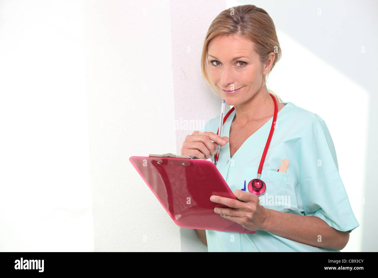 Nurse looking at notes Stock Photo - Alamy