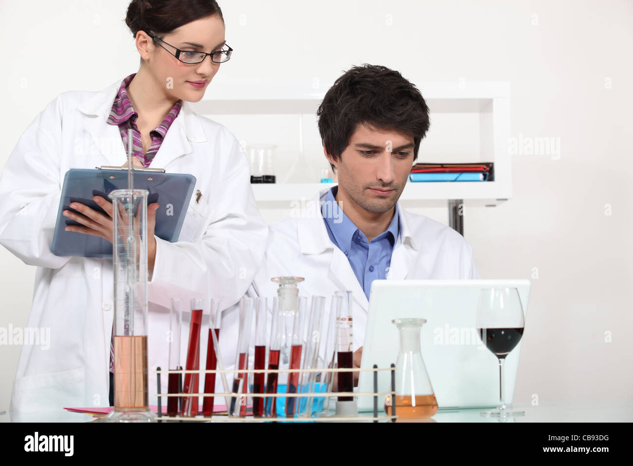 Couple working in a wine laboratory Stock Photo - Alamy
