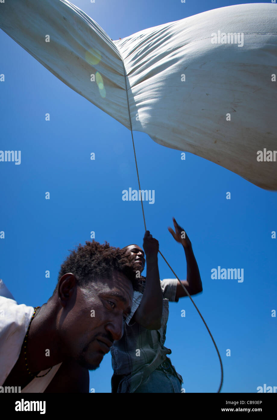 Man with rope during steerage of dhow, dhow race, Lamu, Kenya Stock ...