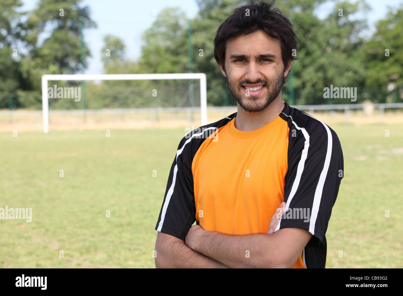 Young football player posing on a football field Stock Photo - Alamy