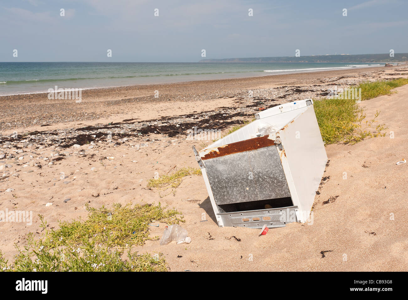 Human rubbish litters beech washed up fridge on isolated beech Stock ...