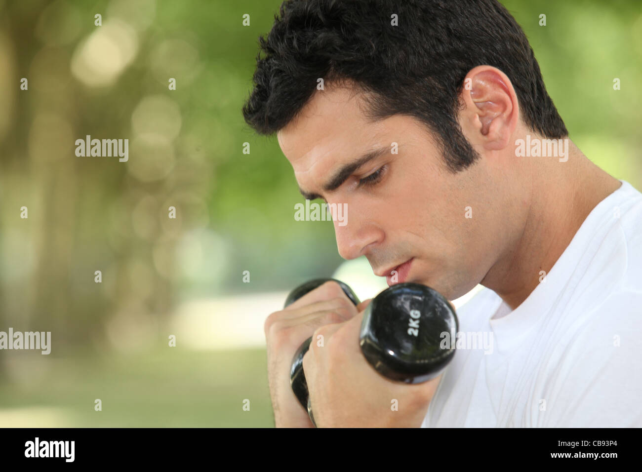 Man using hand weights Stock Photo - Alamy