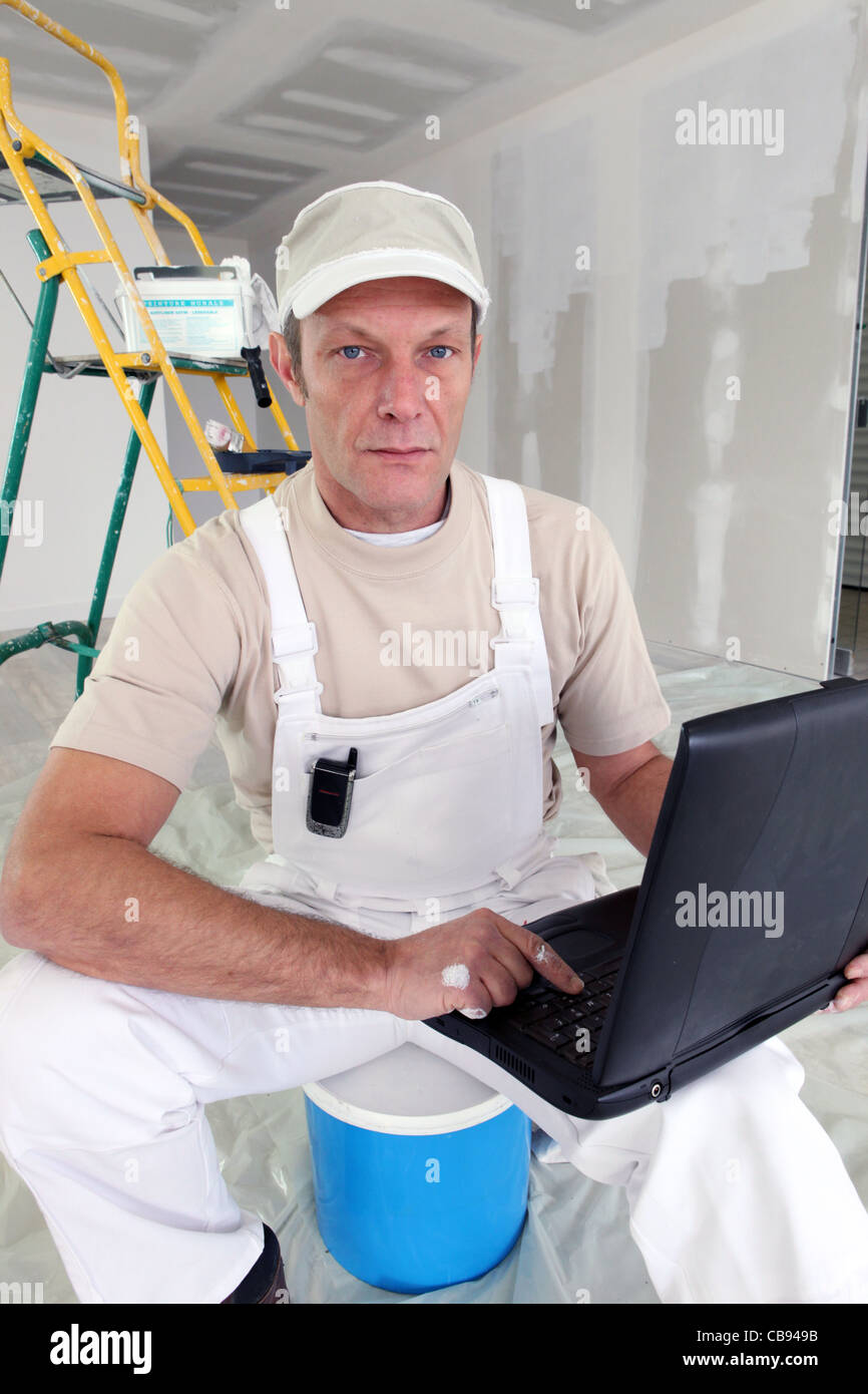 Painter using laptop Stock Photo - Alamy