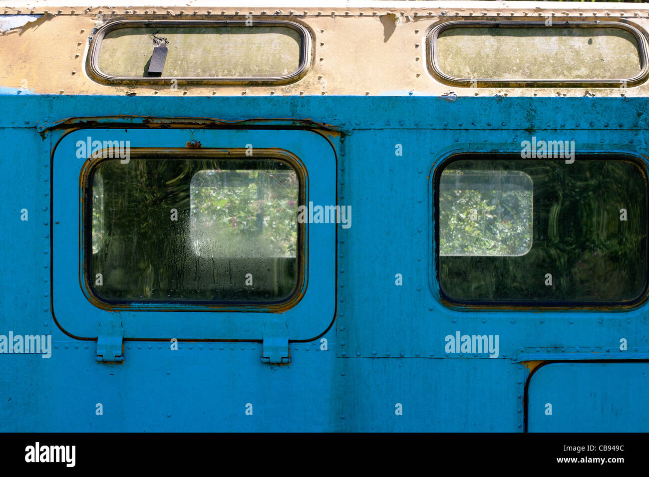 Textured background of blue train car with windows Stock Photo - Alamy