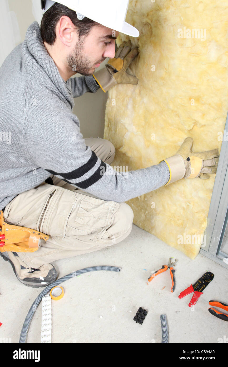 Man installing insulation Stock Photo - Alamy