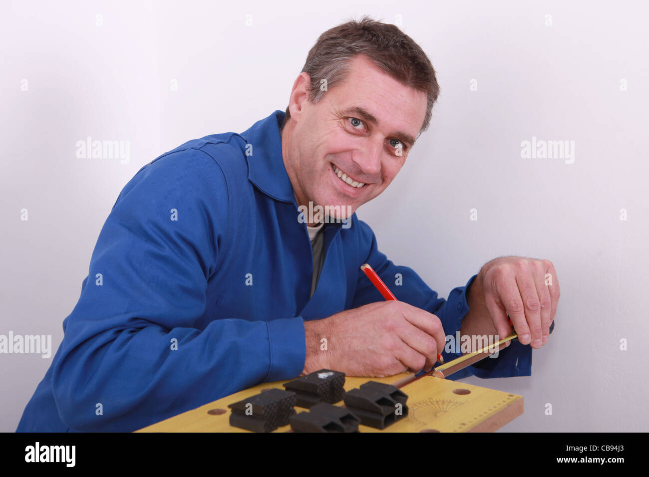 Plumber marking copper pipe Stock Photo - Alamy