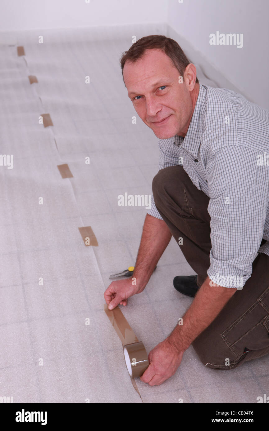 A man laying a new floor Stock Photo - Alamy