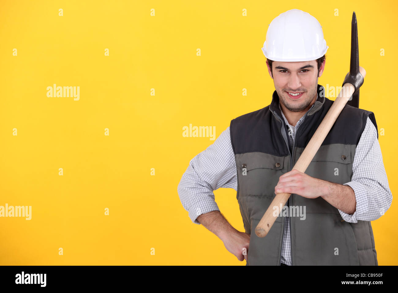 a worker posing with a pickaxe Stock Photo - Alamy