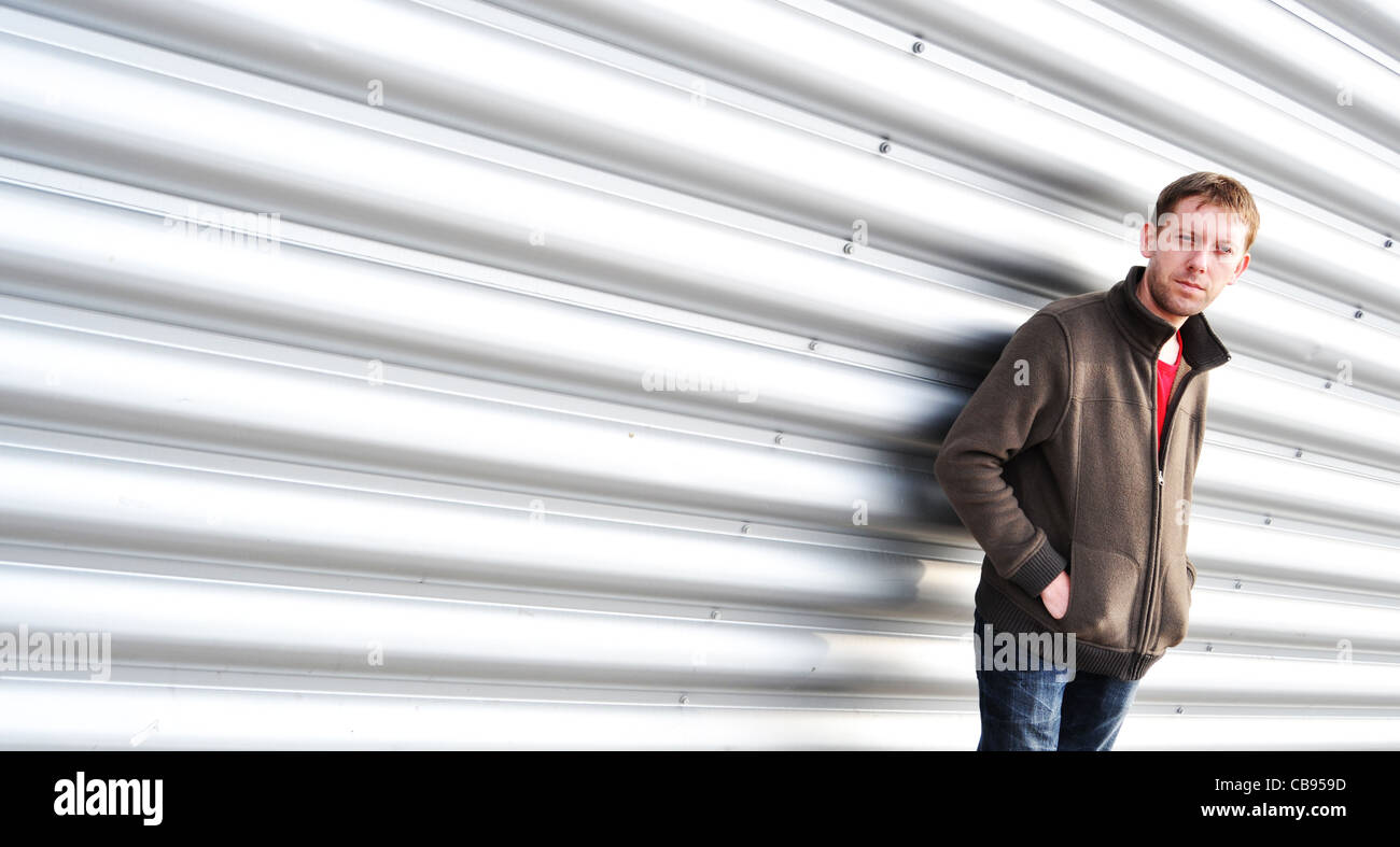 Male model posing against wall Stock Photo - Alamy