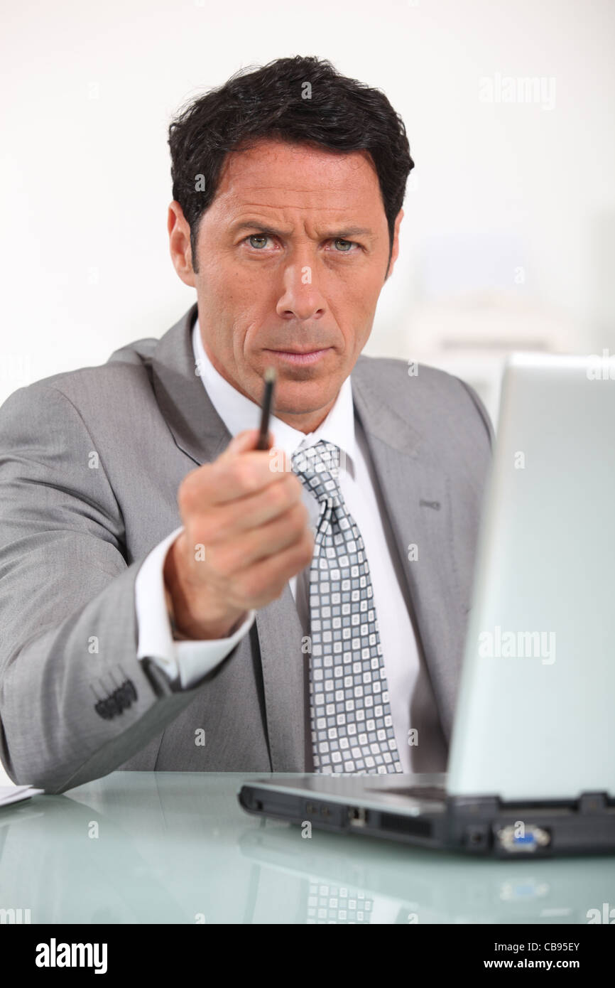 Male executive at laptop Stock Photo - Alamy