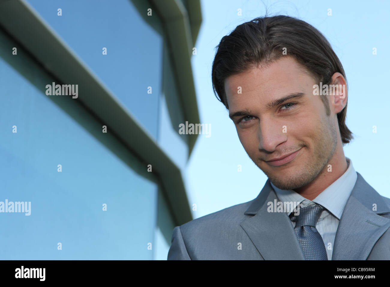 Young businessman smiling Stock Photo - Alamy