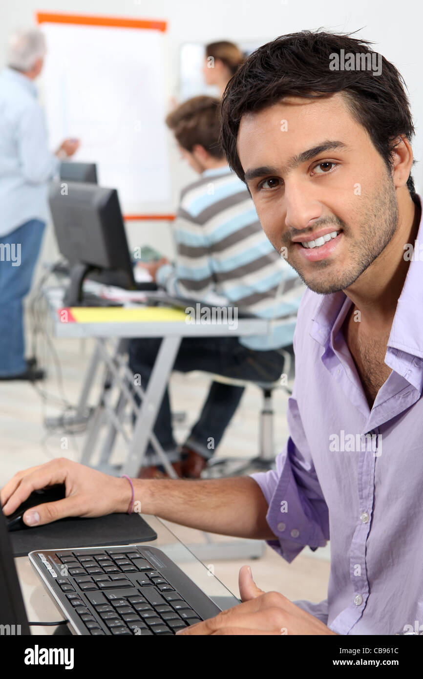 Young man sitting in classroom Stock Photo - Alamy