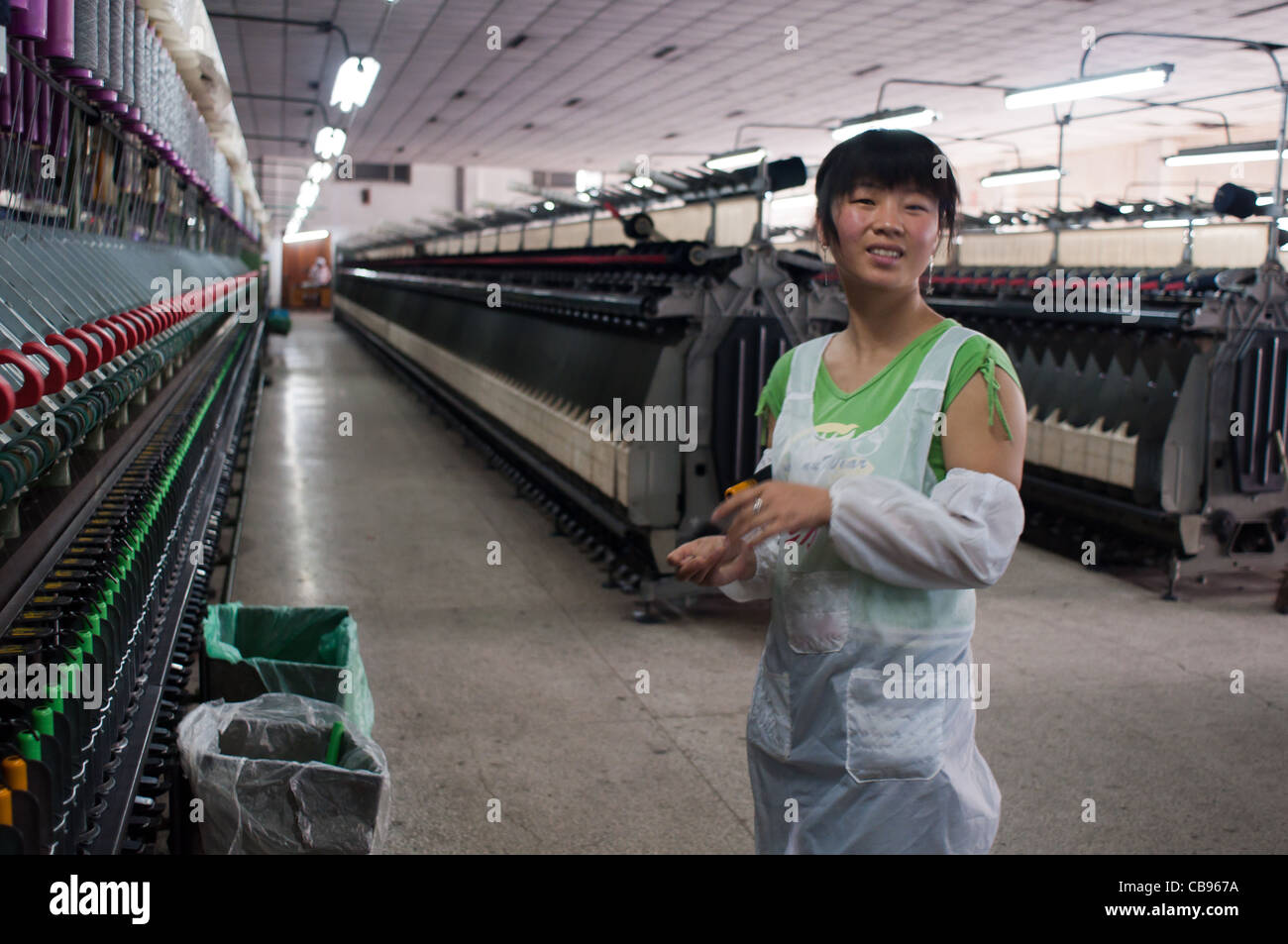 Young Chinese worker in a textile factory, Huaxi Village, China Stock ...
