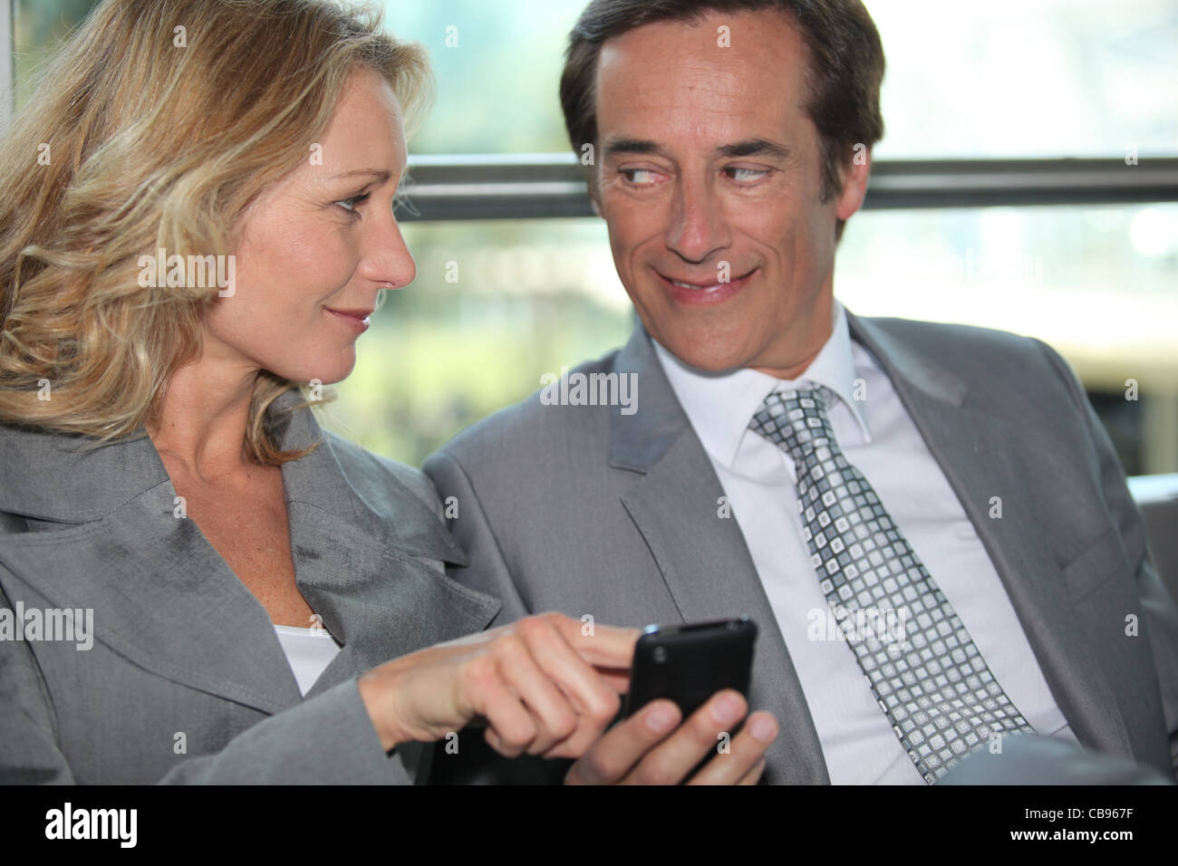Businessman showing blond woman hi-res stock photography and images - Alamy