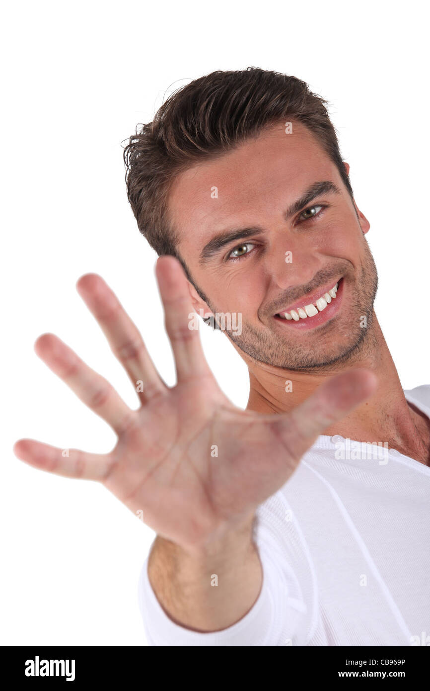 Young man holding out hand Stock Photo - Alamy